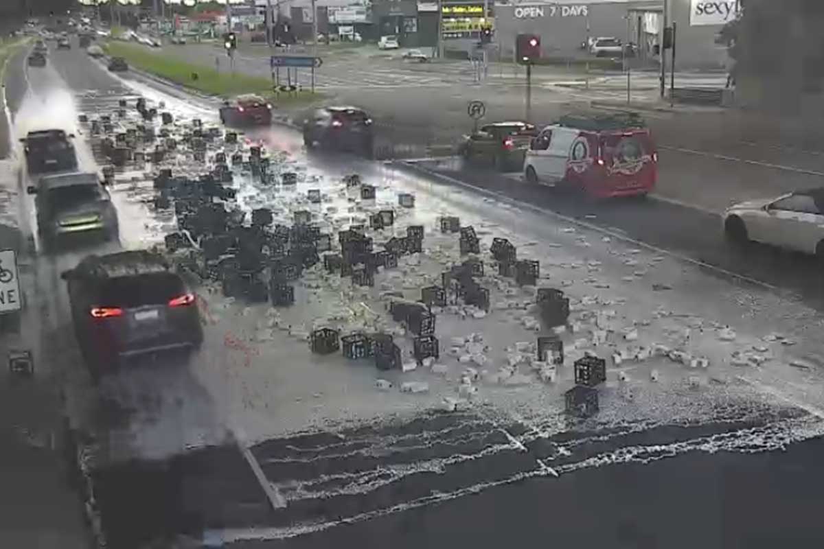 Busy road blocked after dozens and dozens of milk crates fall off truck